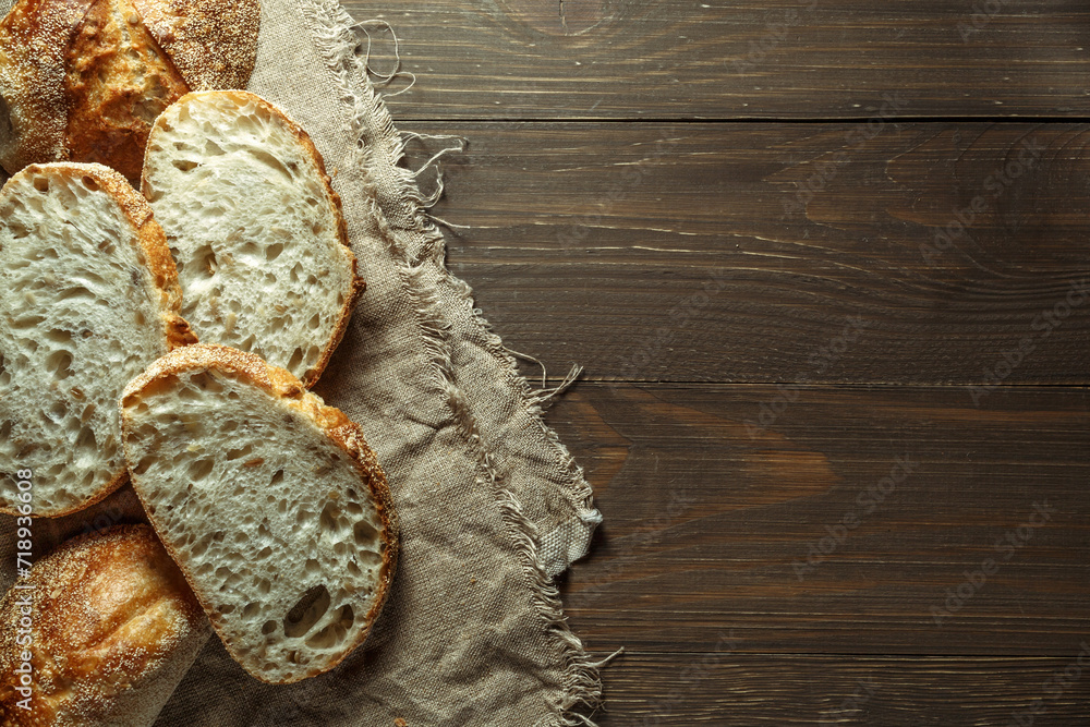 Bread, traditional sourdough bread cut into slices on a rustic wooden ...