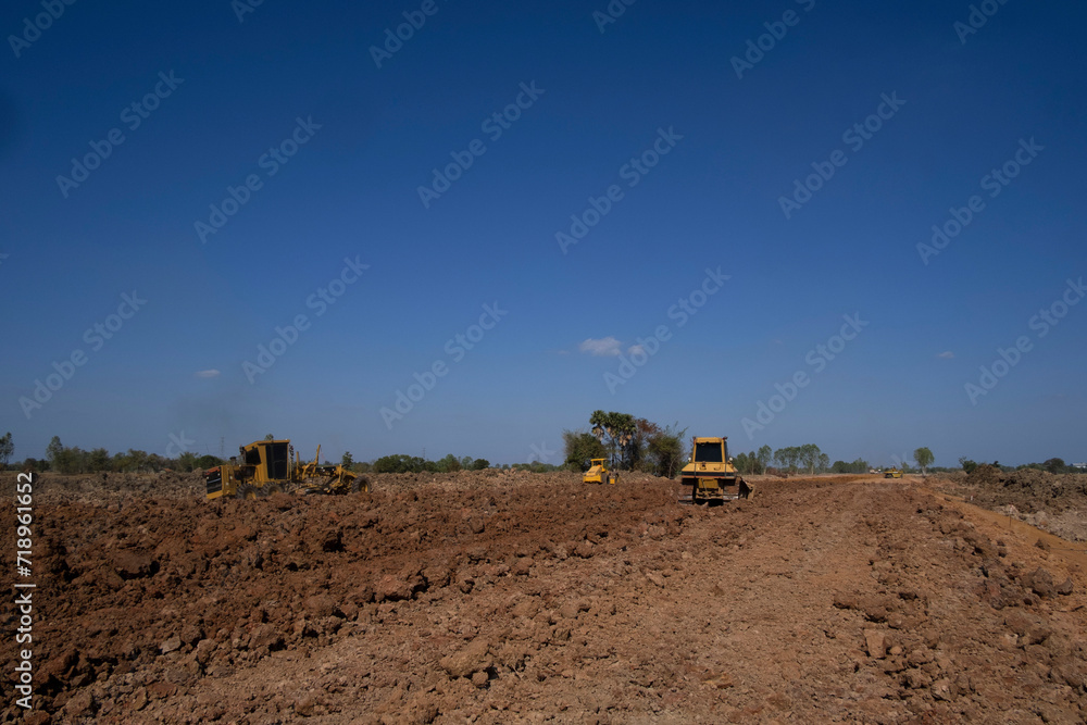 Dozer is pushing dirt. Bulldozer is working gravel surface for new road ...