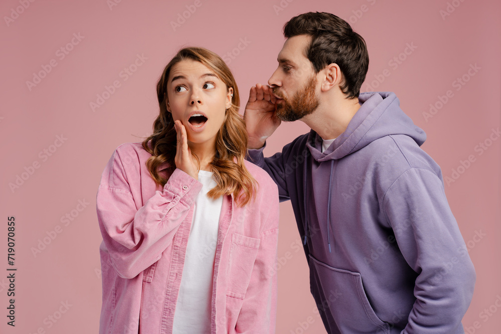 Shock, gossip, share advice. Young man whispering to lady on ear, happy ...