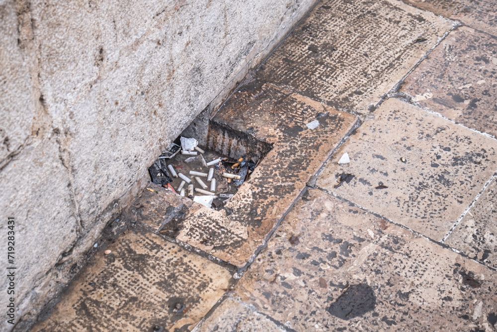 blocked water drain in the stone floor. clogged hole. It's filled with ...