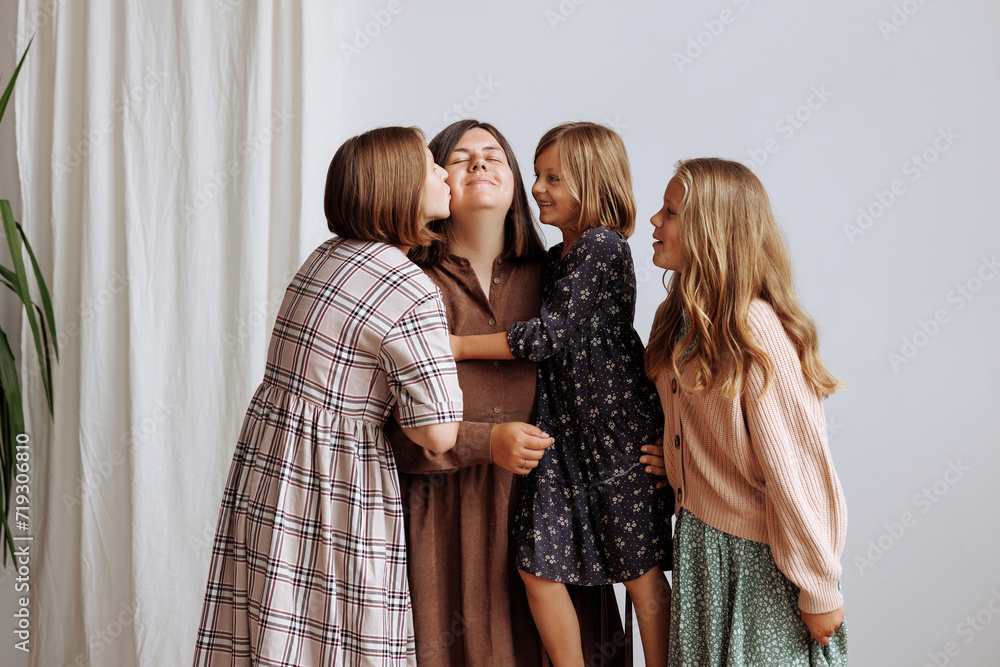 Four Caucasian girls in dresses of pastel and retro colors in a ...