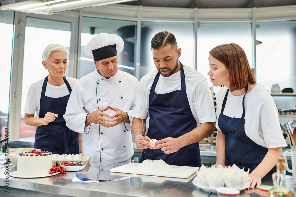good looking chefs watching their african american colleague breaking ...