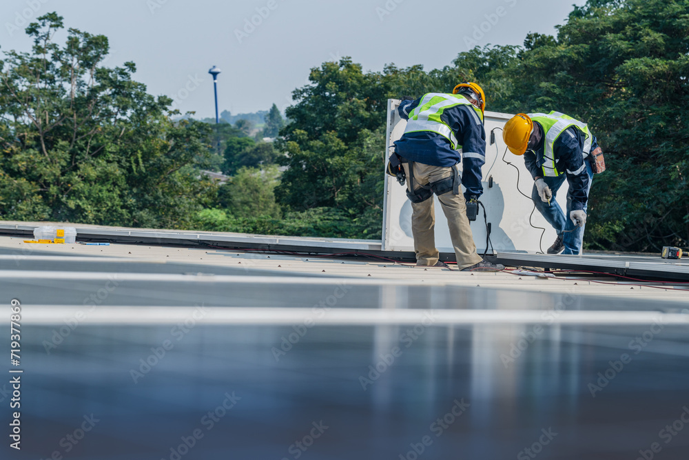 Worker Technicians are working to construct solar panels system on roof ...