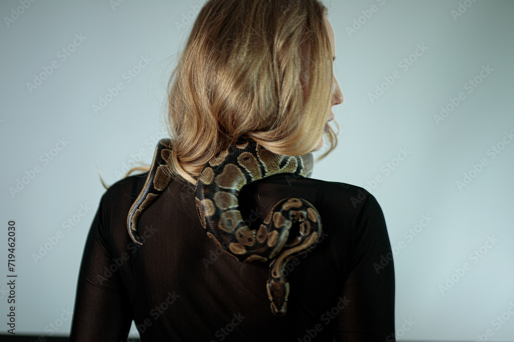 young blond woman with black dress and real snake python Stock Photo ...