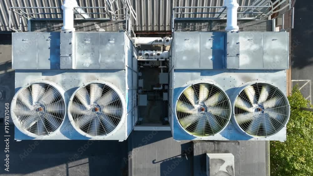 Top down aerial of spinning ventilation AC units on rooftop. Industrial ...