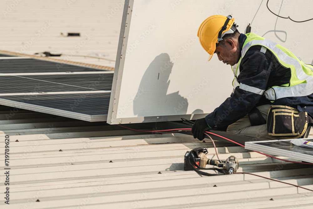 Worker Technicians are working to construct solar panels system on roof ...