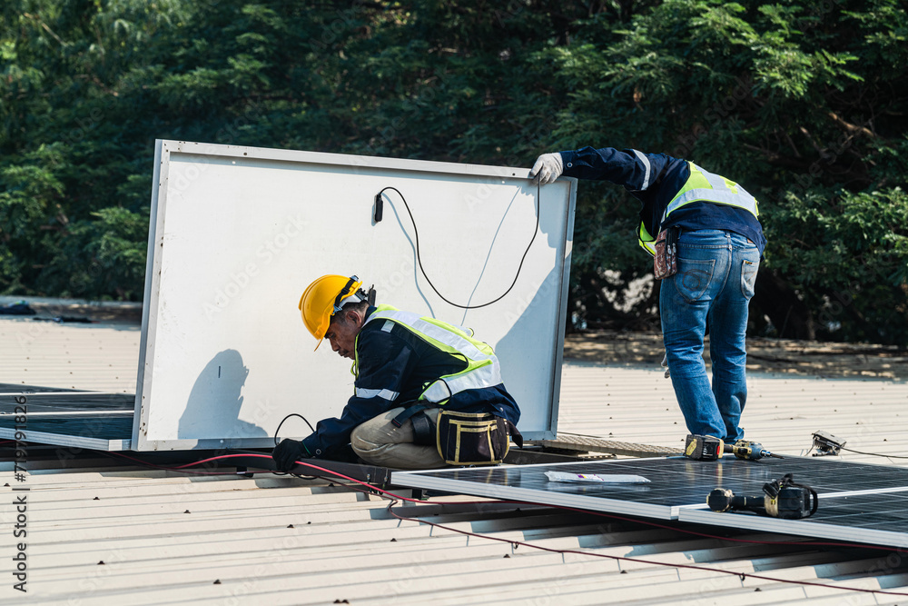Worker Technicians are working to construct solar panels system on roof ...