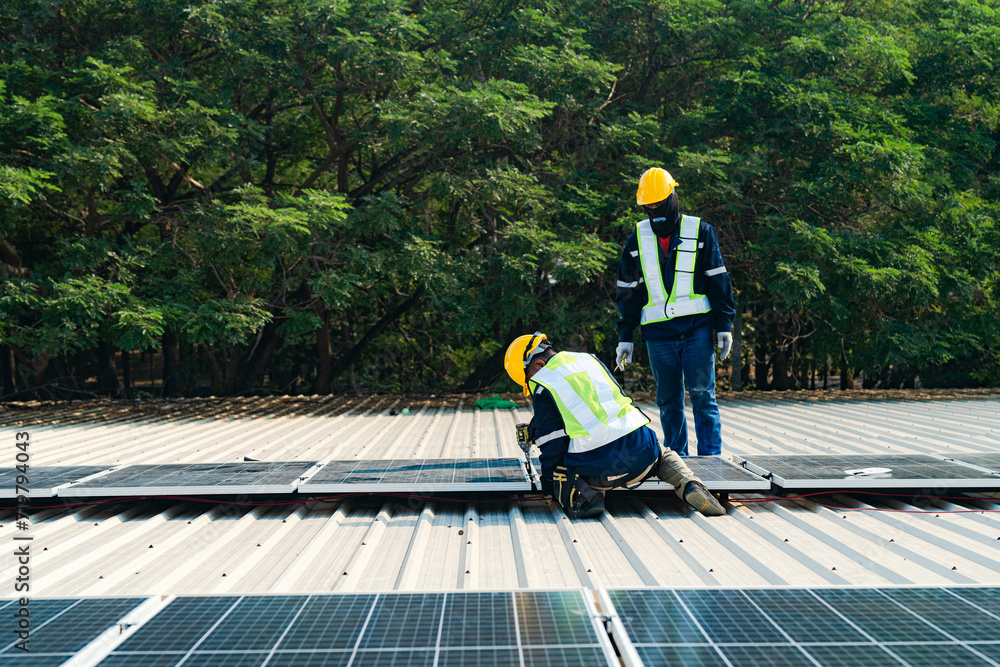 Worker Technicians are working to construct solar panels system on roof ...