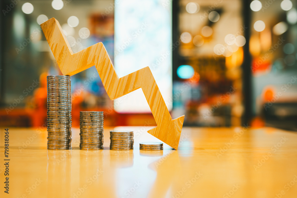 A pile of money and a arrow pointing down symbolizes falling currency ...