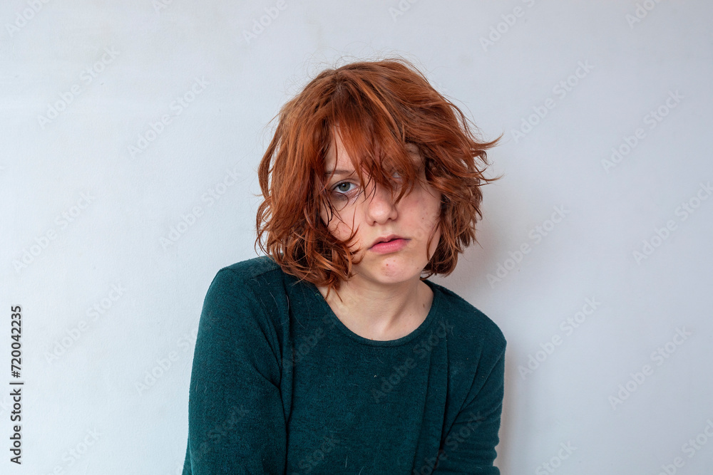 teenage girl with red hair is crying in her room. Emotion management ...
