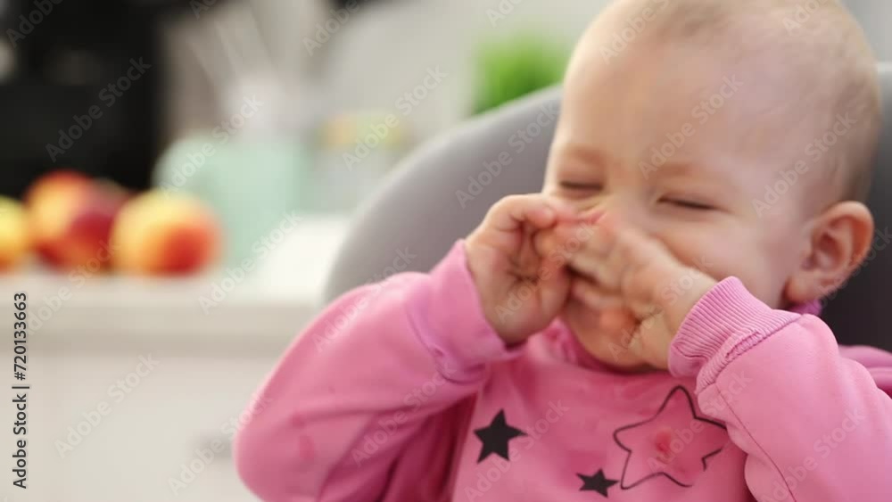 A little caucasian boy, one year old, sneezes and snot comes out of his ...