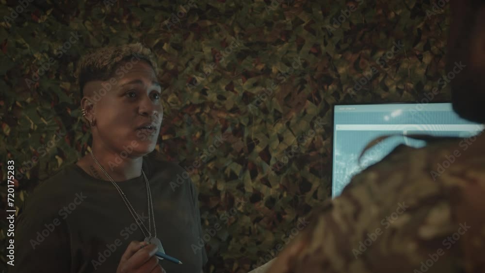 Over shoulder of Biracial female military surveillance worker wearing ...