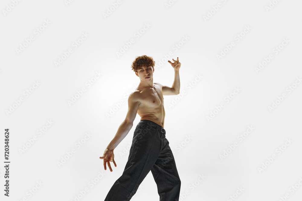 Young Caucasian man, ballet dancer performing against white studio ...
