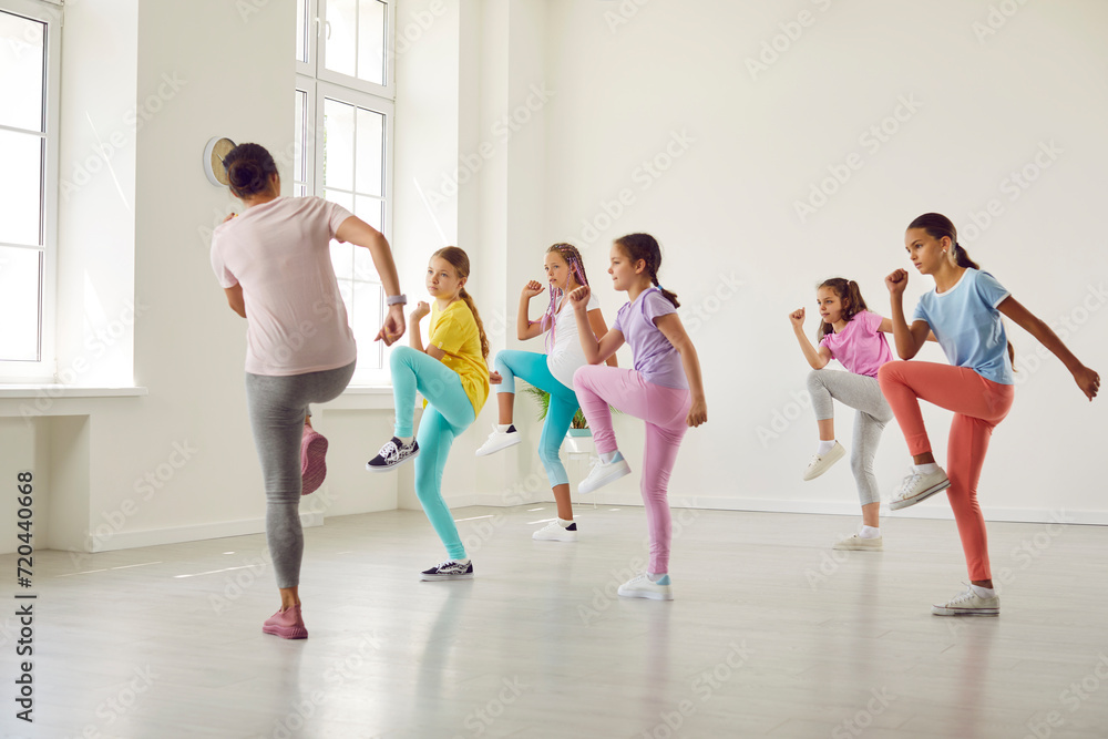 Group of children at dance class. Kids doing sports exercises with ...