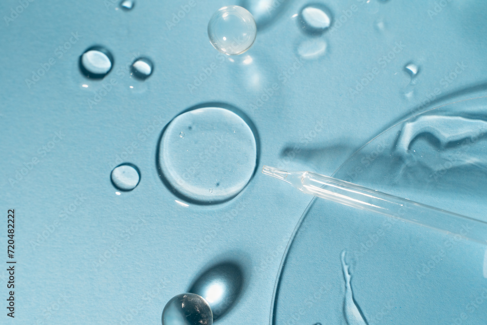 Drug development. Skin care cosmetics. Medical pipette on a blue ...