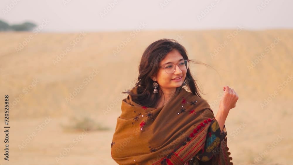 Portrait of beautiful Indian girl wearing shawl and walking in Thar ...