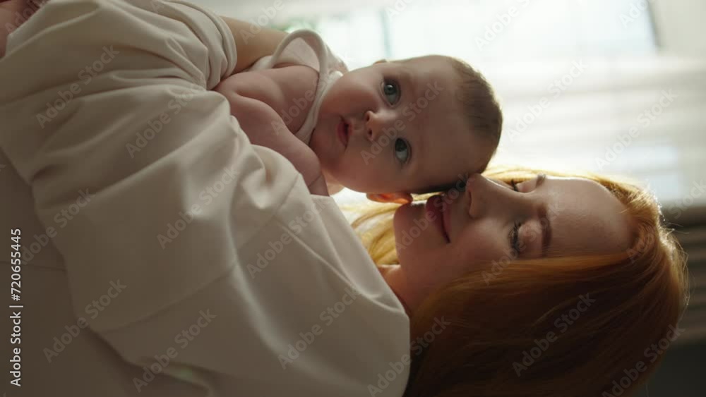Woman mother hugging baby lovingly softly. Young mother woman hugs ...