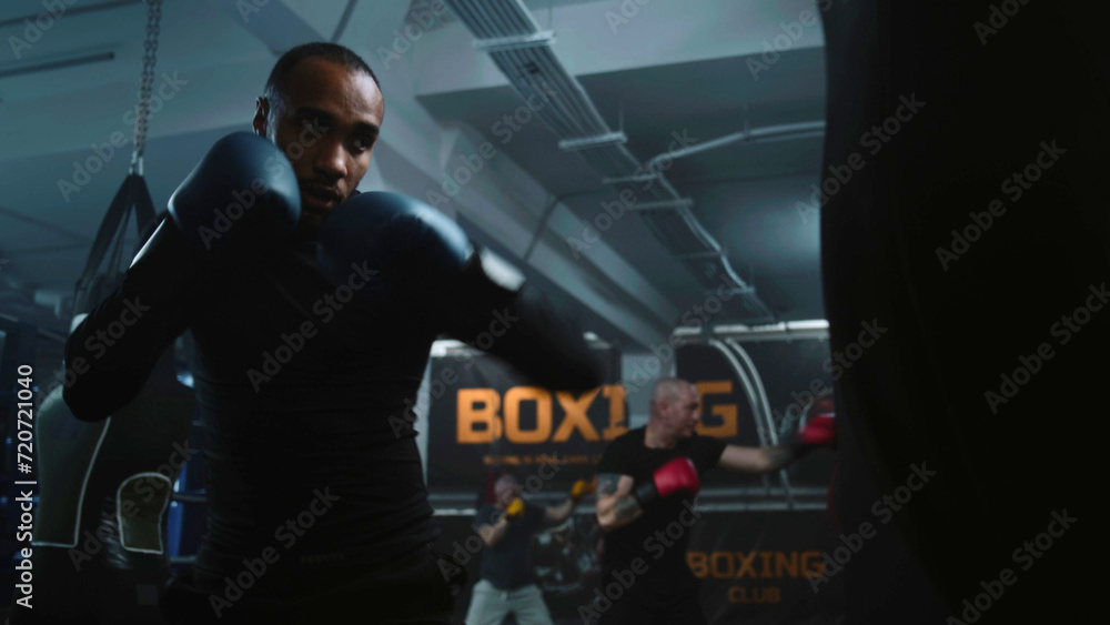 African American fighter listens coach command and starts hitting ...