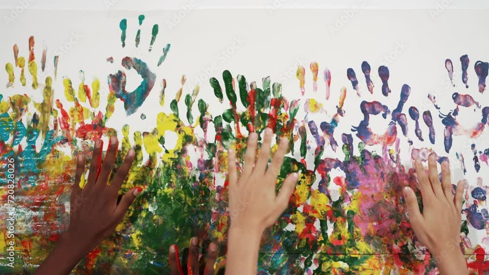 Diverse student hand placed on colorful stained wall while switch place ...