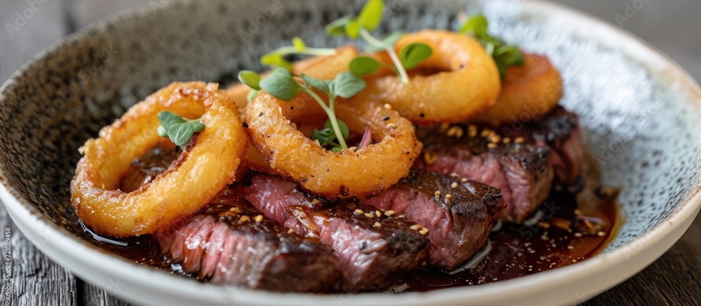 Cuban dry aged angus steak with onion rings in soy sauce, served in a ...