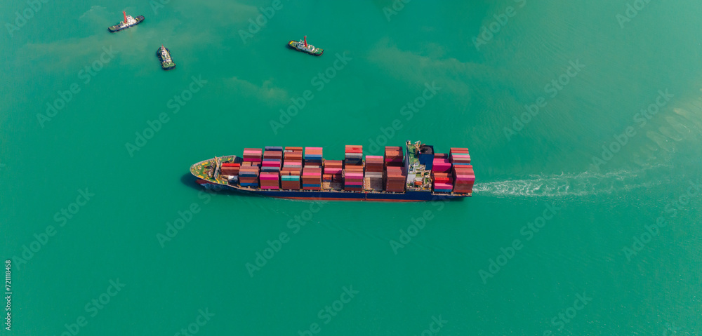 Aerial side view of cargo ship carrying container and running for ...