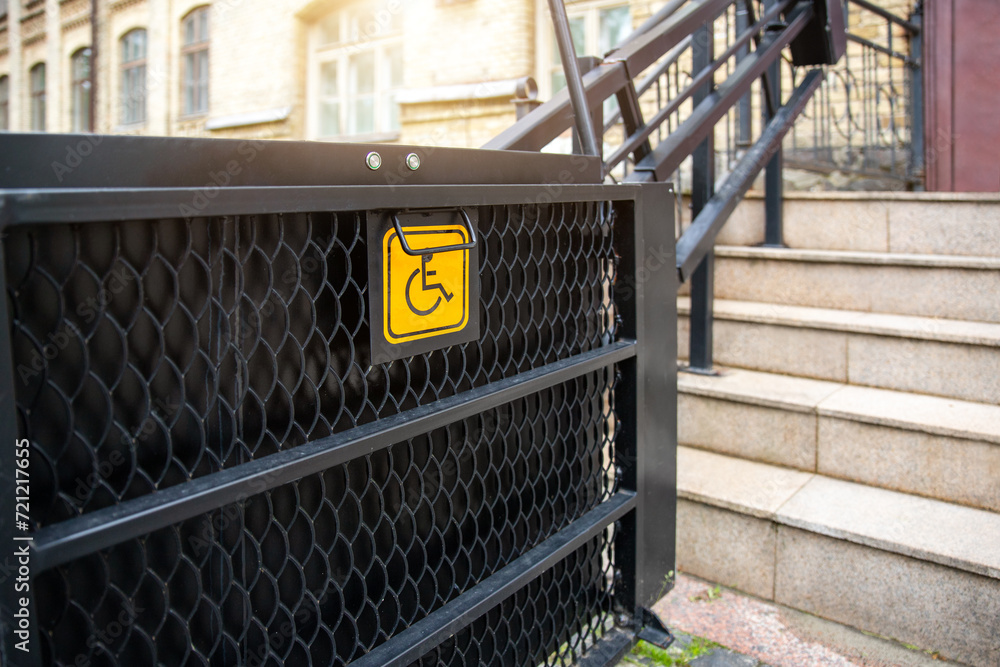 Electric platform lift at building staircase for disabled people with ...
