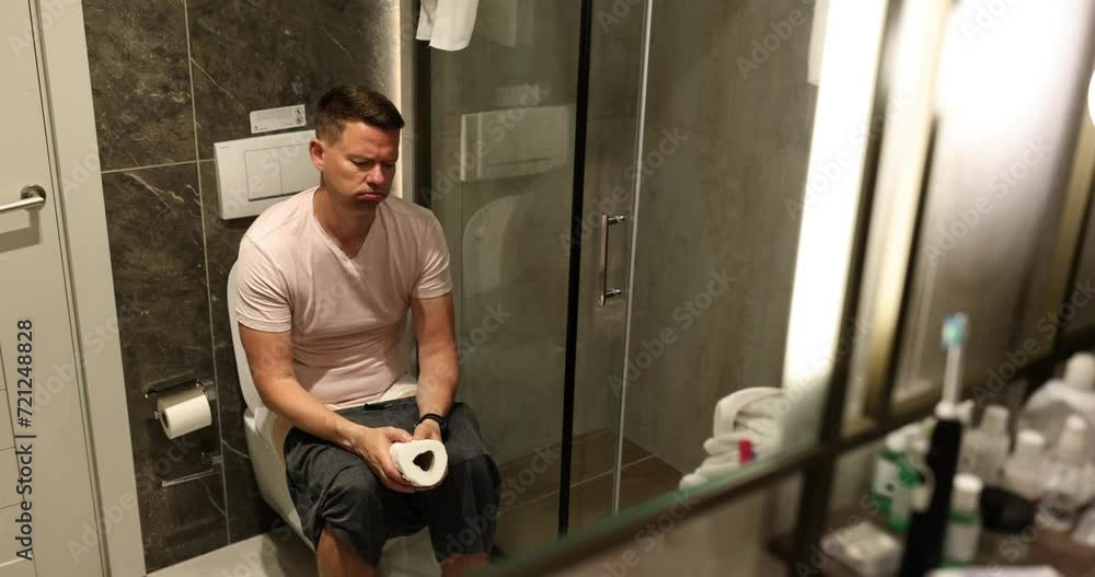 Man suffering from hemorrhoids on toilet in toilet. Guy with diarrhea ...