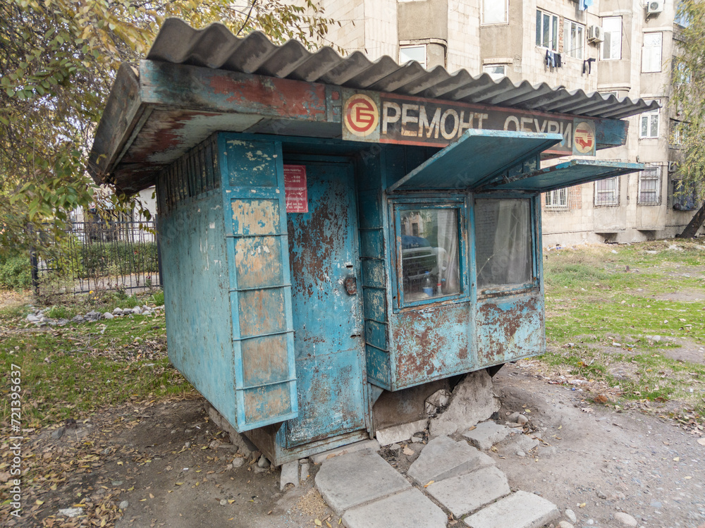 old soviet shoe repair kiosk with shabby peeled blue paint on street of ...