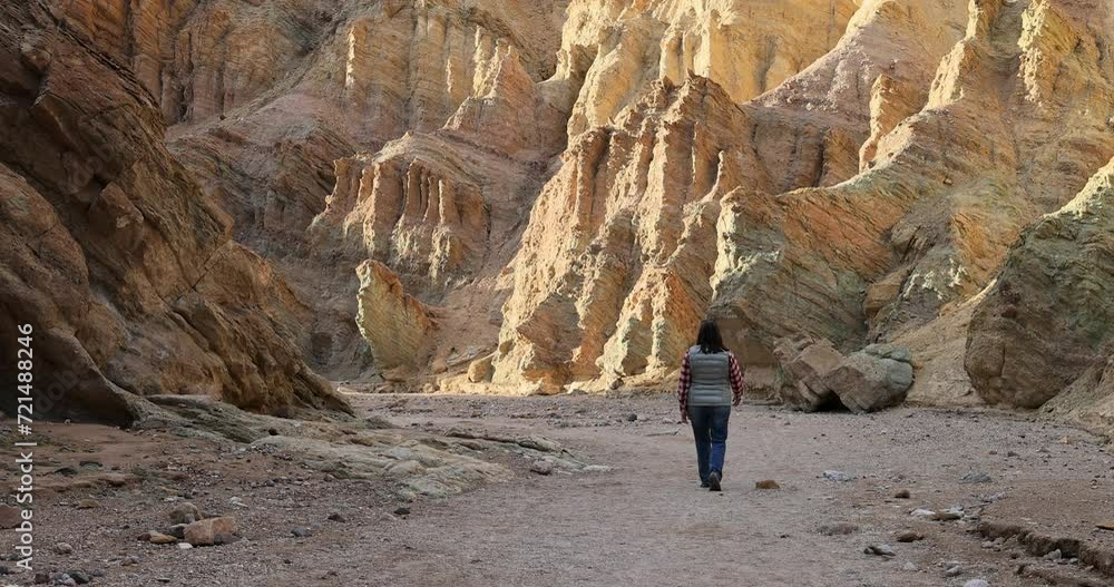Death Valley female hiking narrow slot canyon. Largest national park in ...