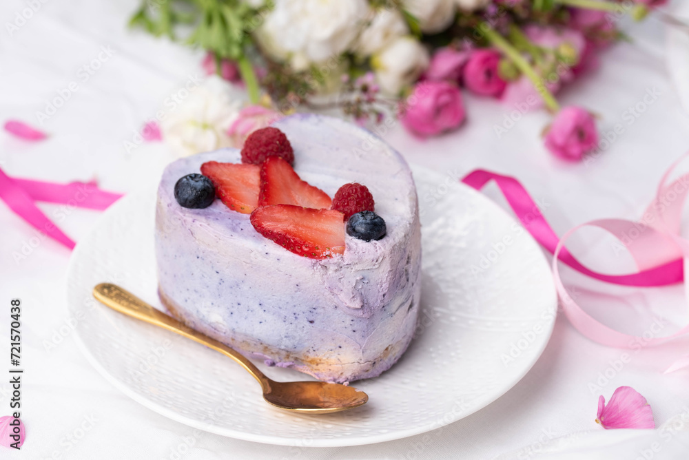 Trendy bento cake in love heart shape form on a light breakfast in bed ...