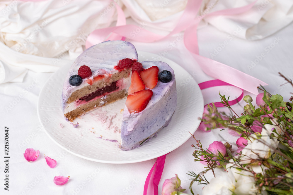 Trendy bento cake in love heart shape form on a light breakfast in bed ...
