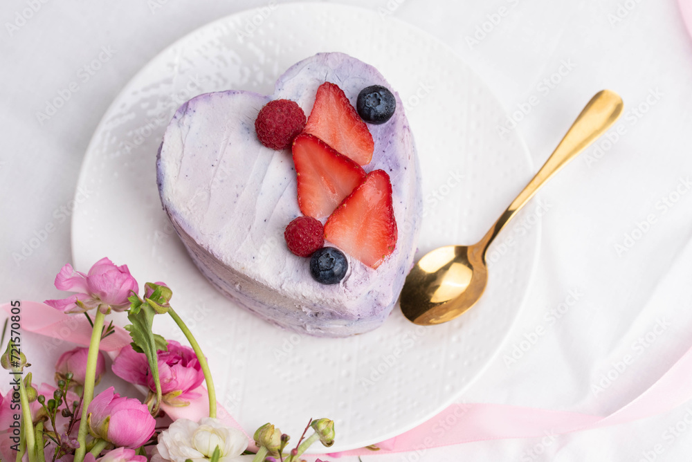 Trendy bento cake in love heart shape form on a light breakfast in bed ...