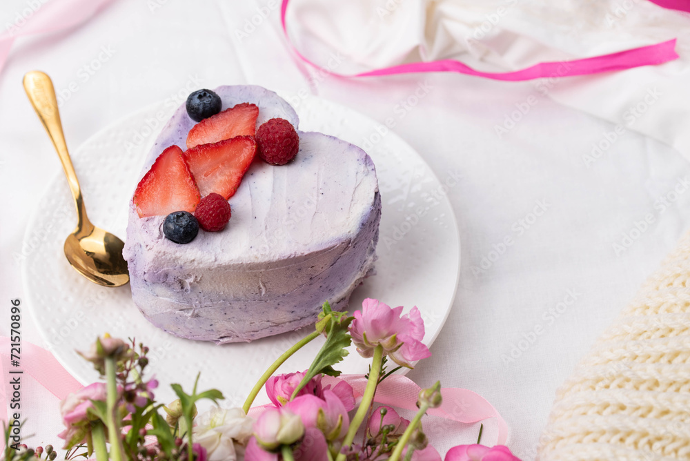 Trendy bento cake in love heart shape form on a light breakfast in bed ...