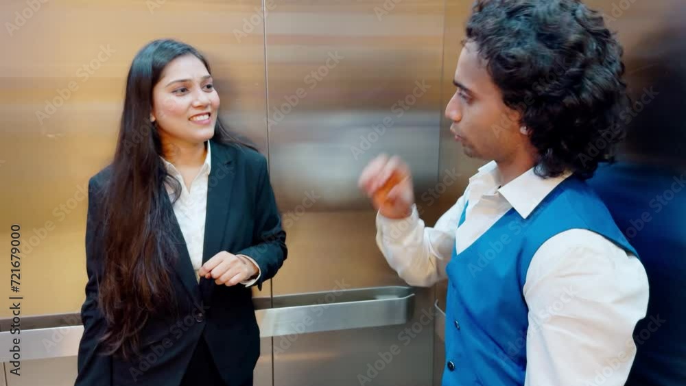 Two professional man women engaged in a conversation in a modern office ...