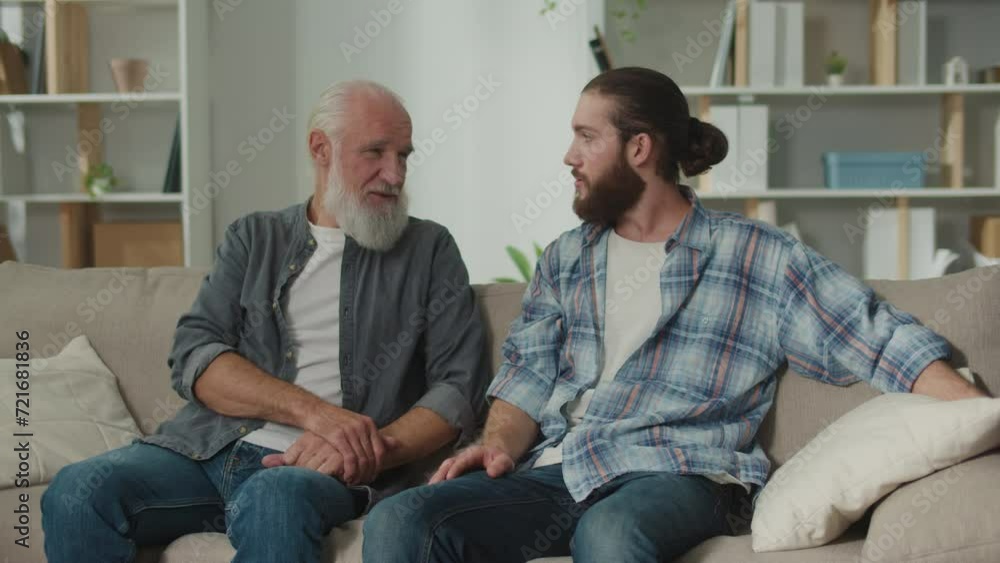 Deep conversation between generations young man and elder on the couch ...