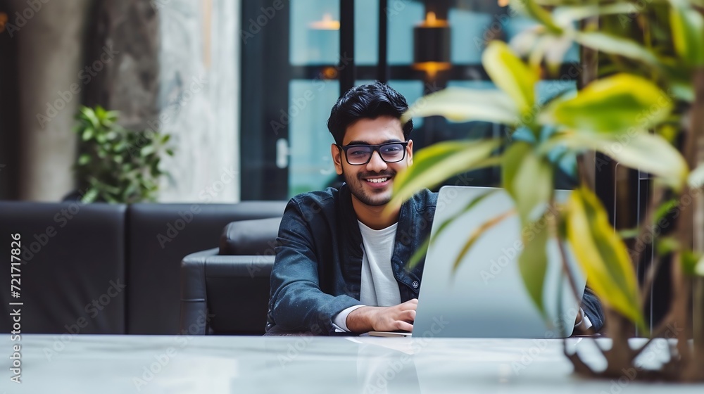 Generative AI : Smiling indian businessman working on laptop in modern ...