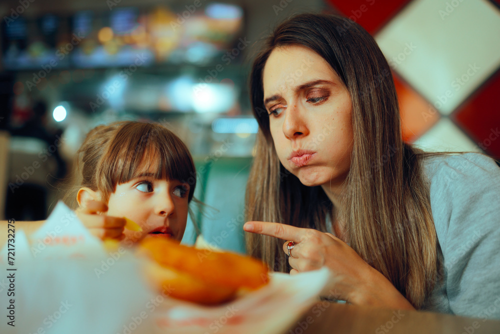 Mom Pointing to her Little Girl Eating Unhealthy Foods. Unhappy mother ...