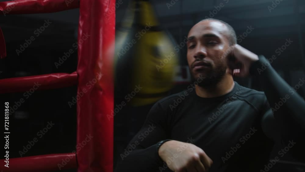 Focused African American fighter hits punching bag during workout in ...