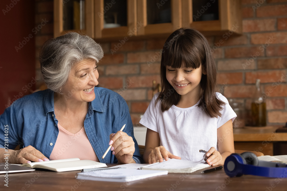 Learning time. Friendly mature latina woman tutor consult preteen pupil ...