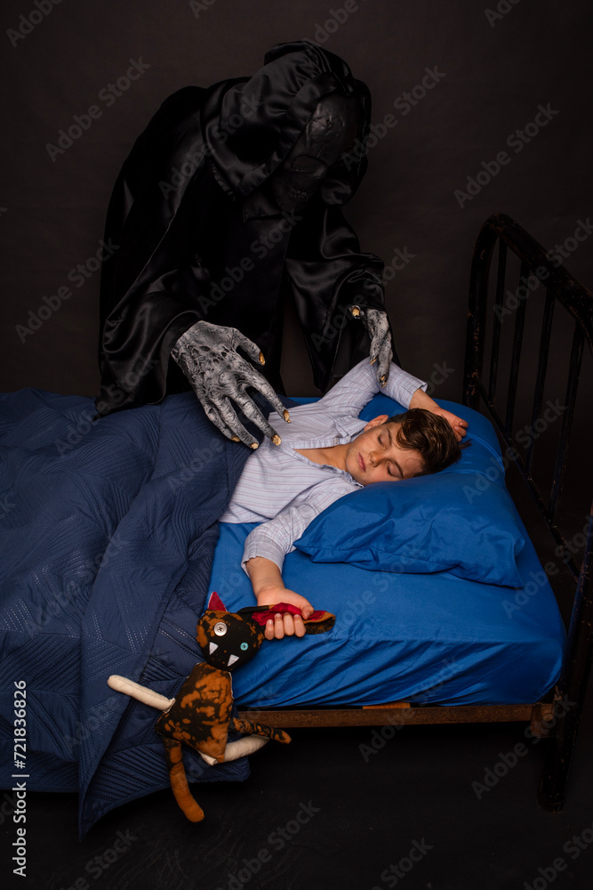 A frightening creature reaches its withered hands towards a young boy ...