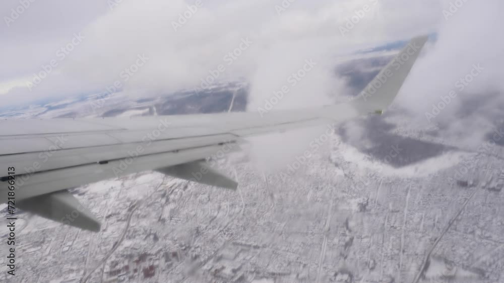 Vidéo Stock Flying over snow capped city. View of snowy landscape under ...