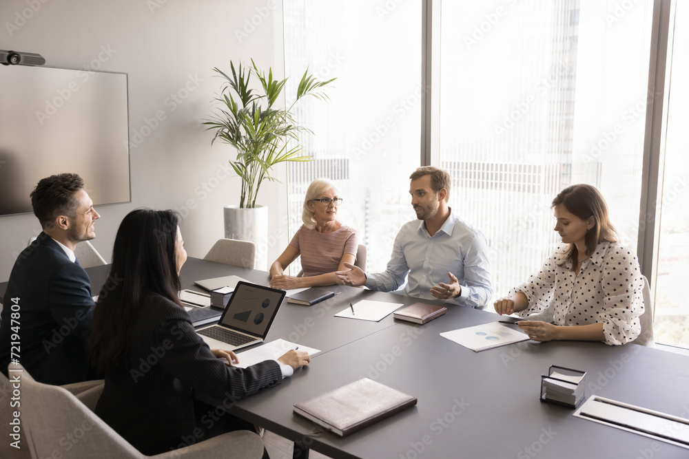 Male business coach training diverse team of employees. Male boss ...