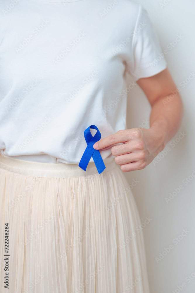 Woman holding Blue ribbon with having Abdomen pain. March Colorectal ...
