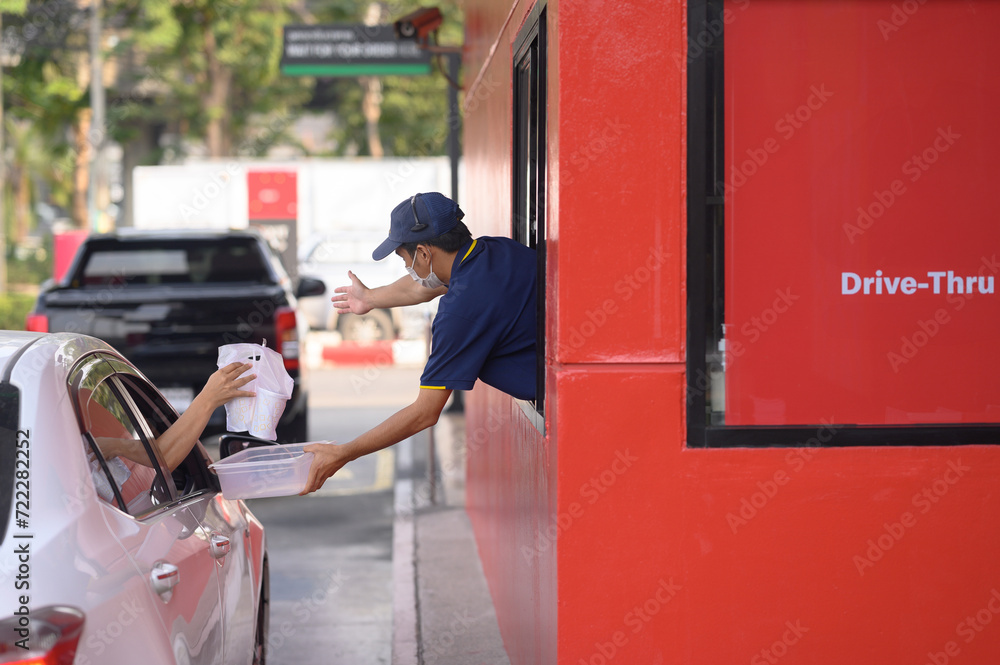 Men are picking up food from drive-thru counters and taking it out to ...