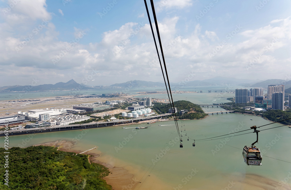 Scenic view of gondolas of Ngong Ping Cable Car (Skyrail) gliding over ...