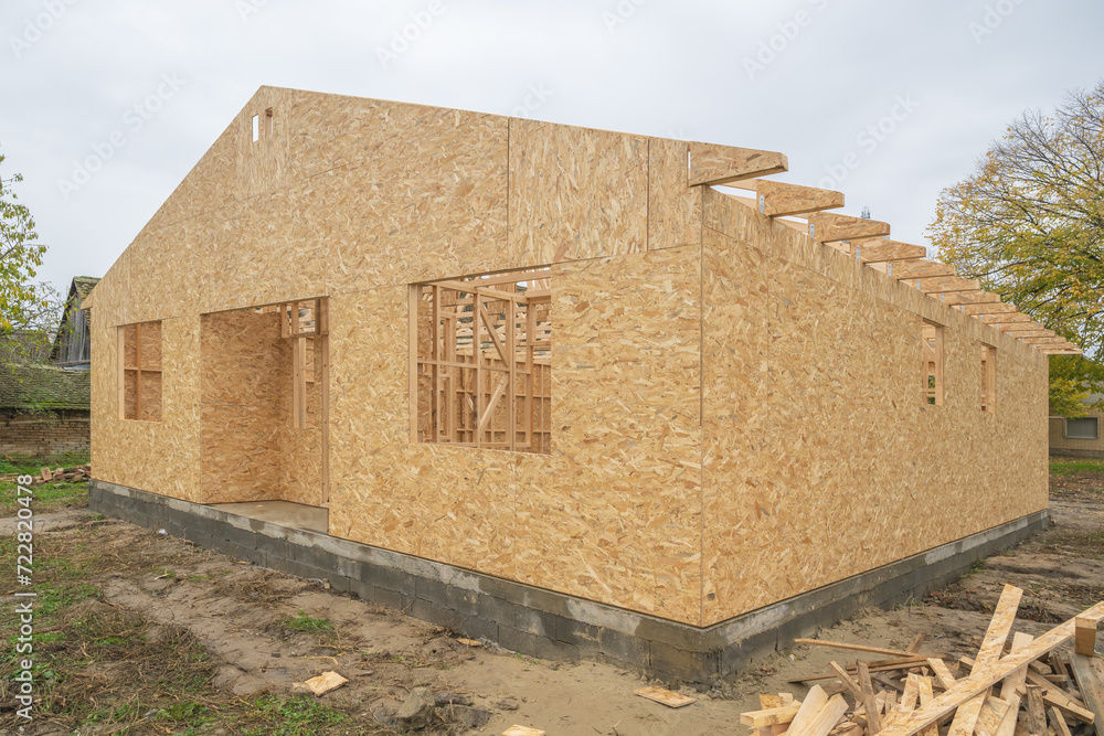 Prefabricated wooden house construction site, wood beam joists and wood ...
