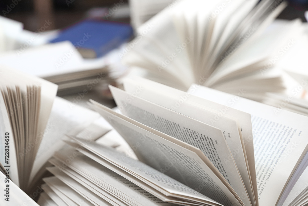 stack of books, close up. Open book on the table in library. Back to ...