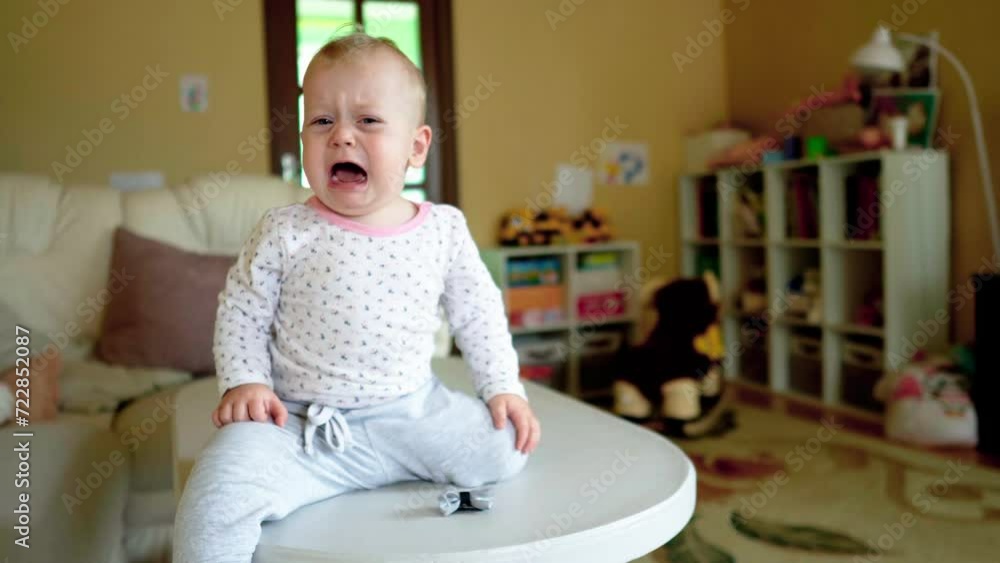 Cute baby crying bitterly, caucasian child with blonde hair sitting on ...