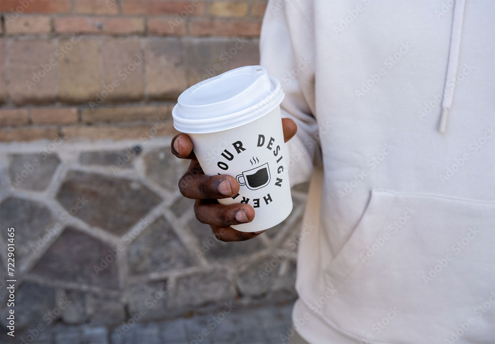 Mockup of man holding customizable paper cup Stock Template | Adobe Stock