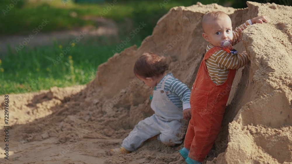 baby children play in the sand sandbox. happy family kid dream concept ...